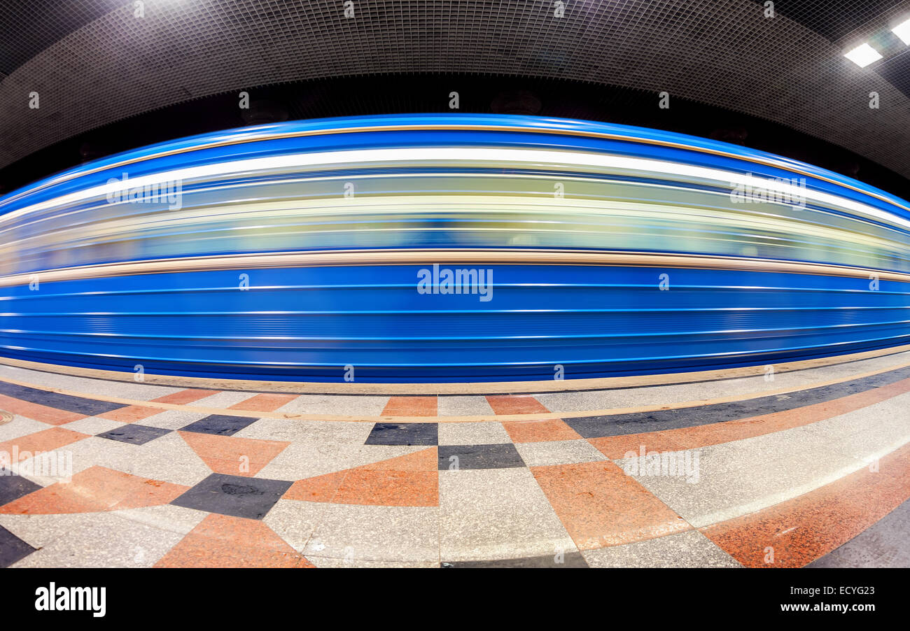 Blue subway train in motion at the underground station. Wide angle ...