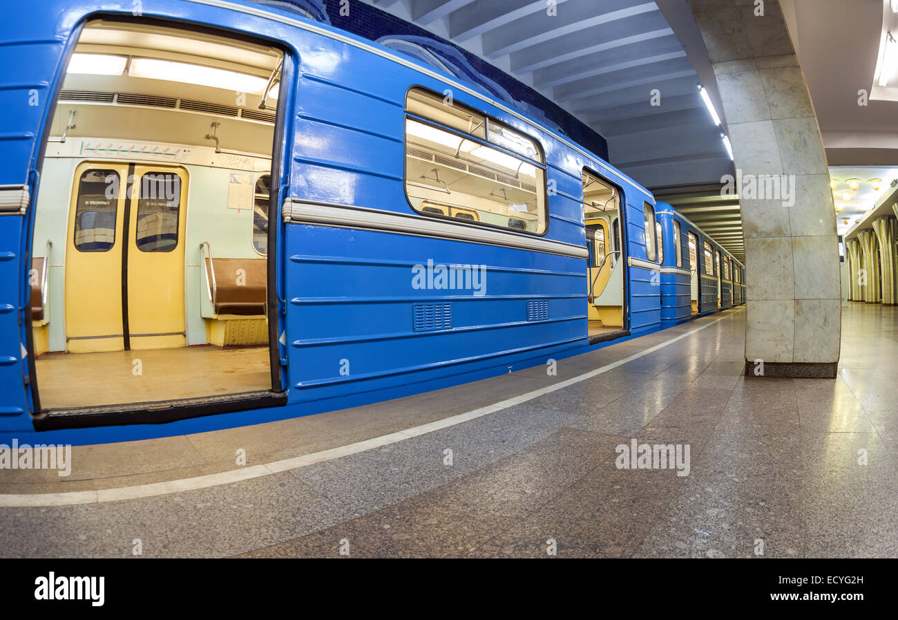 Blue subway train standing at the underground station. Wide angle Stock ...