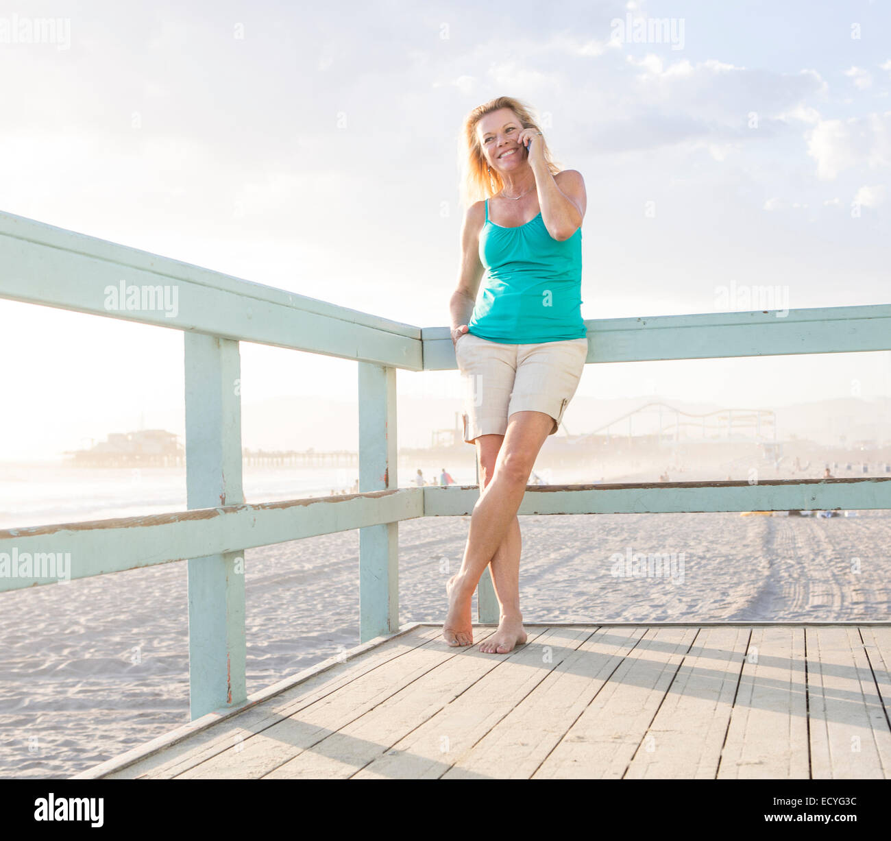 Woman crossed legs beach hi-res stock photography and images - Alamy