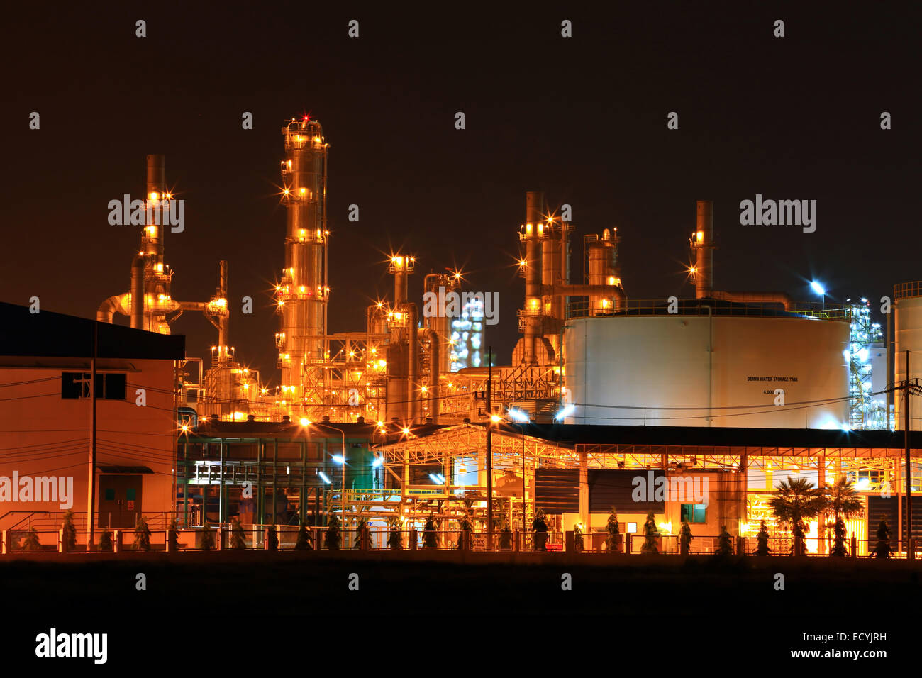 closeup of petrochemical oil refinery plant and water storage tank ...