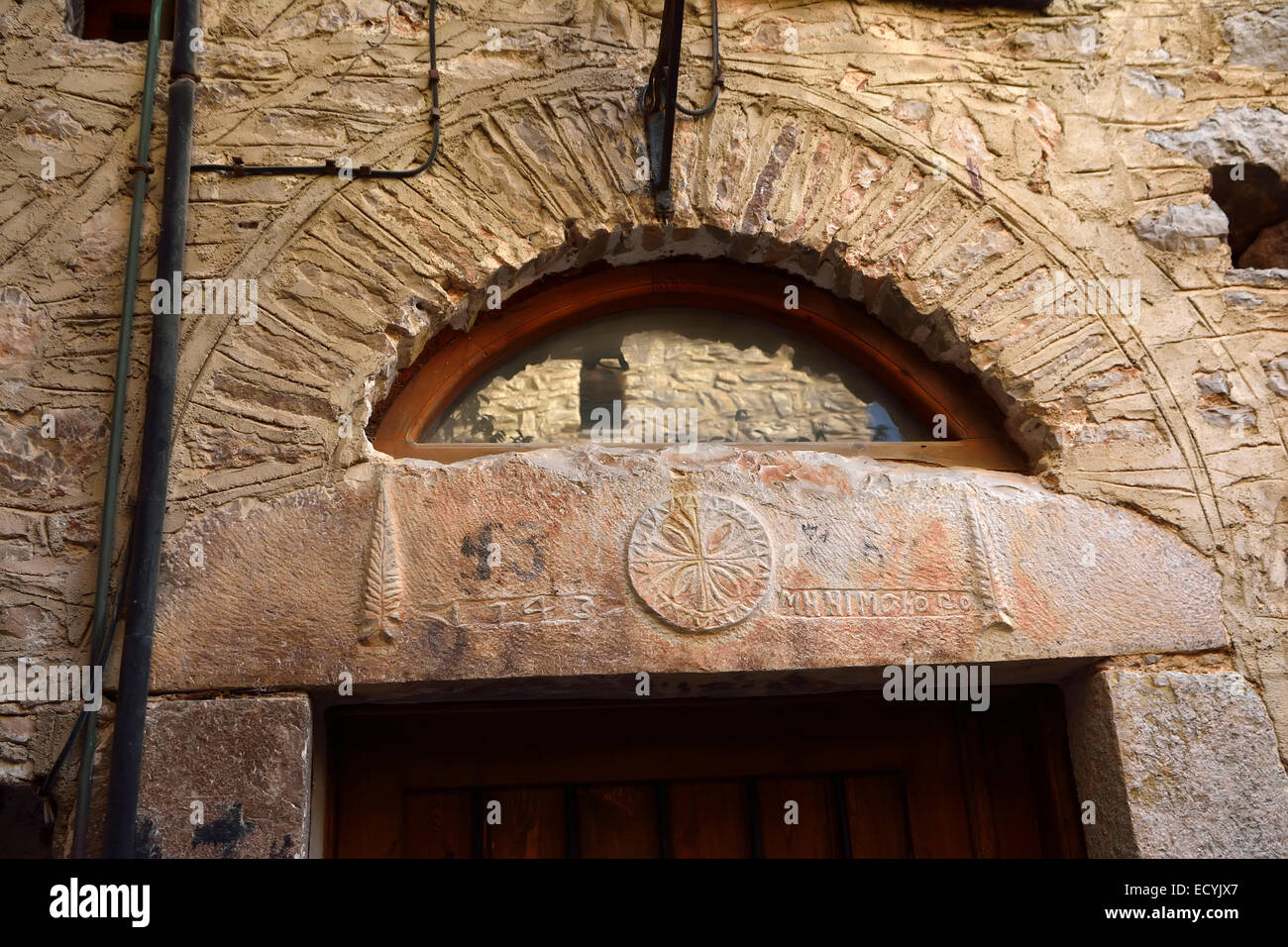 Stone plinth above door in Mesta, Chios, with date and carving Stock ...