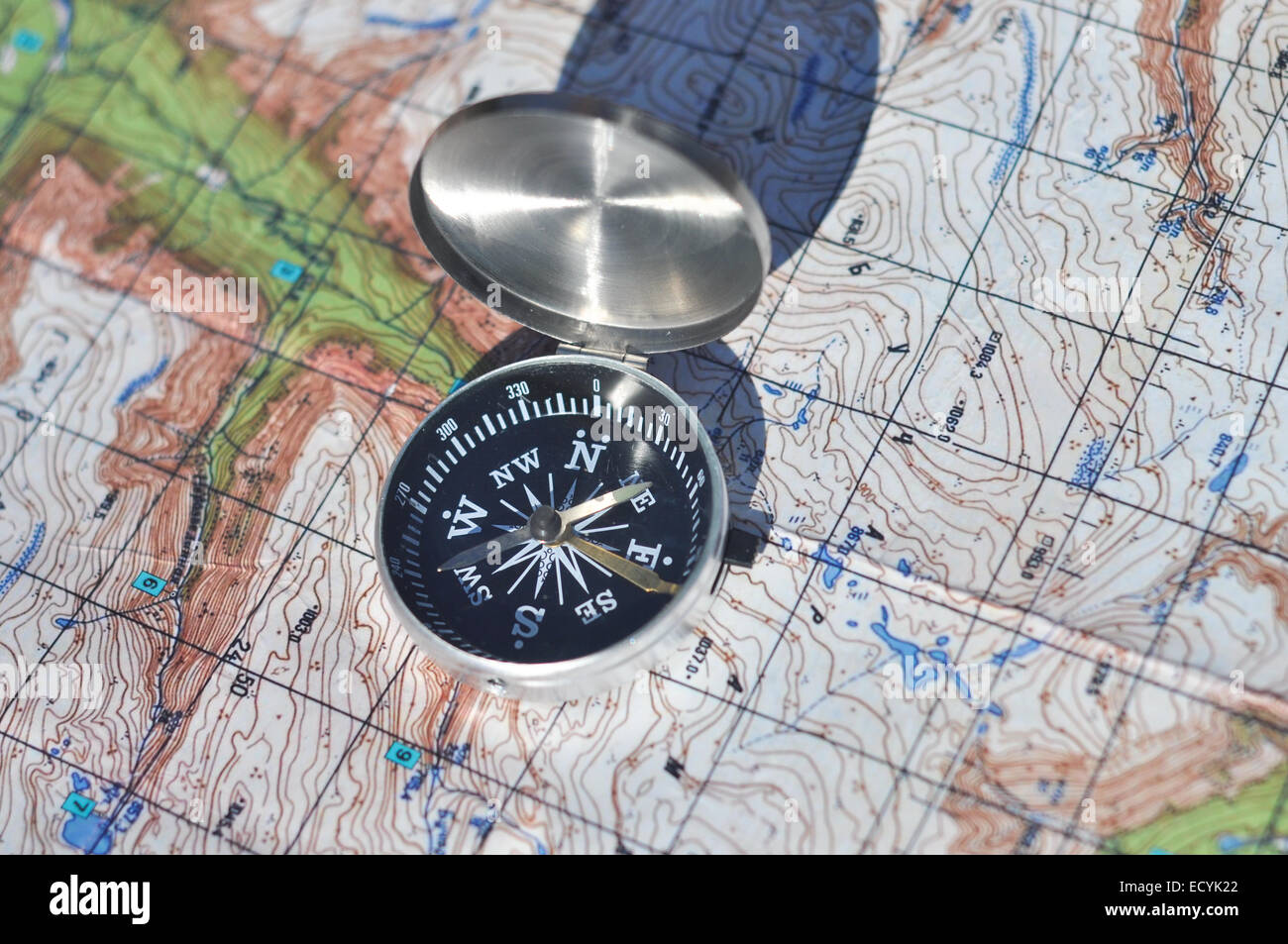 Compass and map. The magnetic compass is located on the topographic map ...