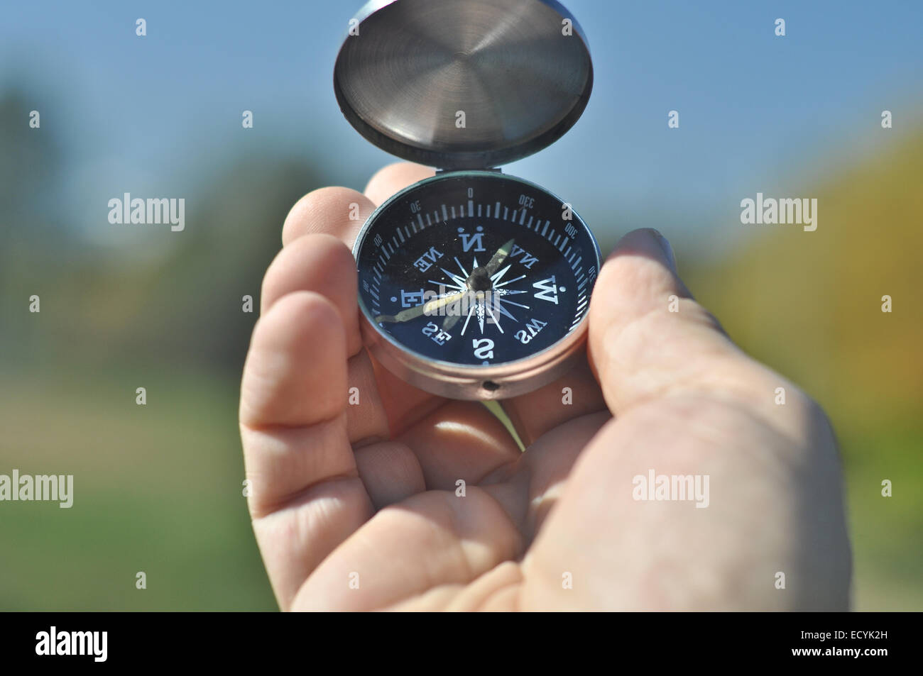 Compass in hand. The magnetic compass lies in a man's hand on a ...