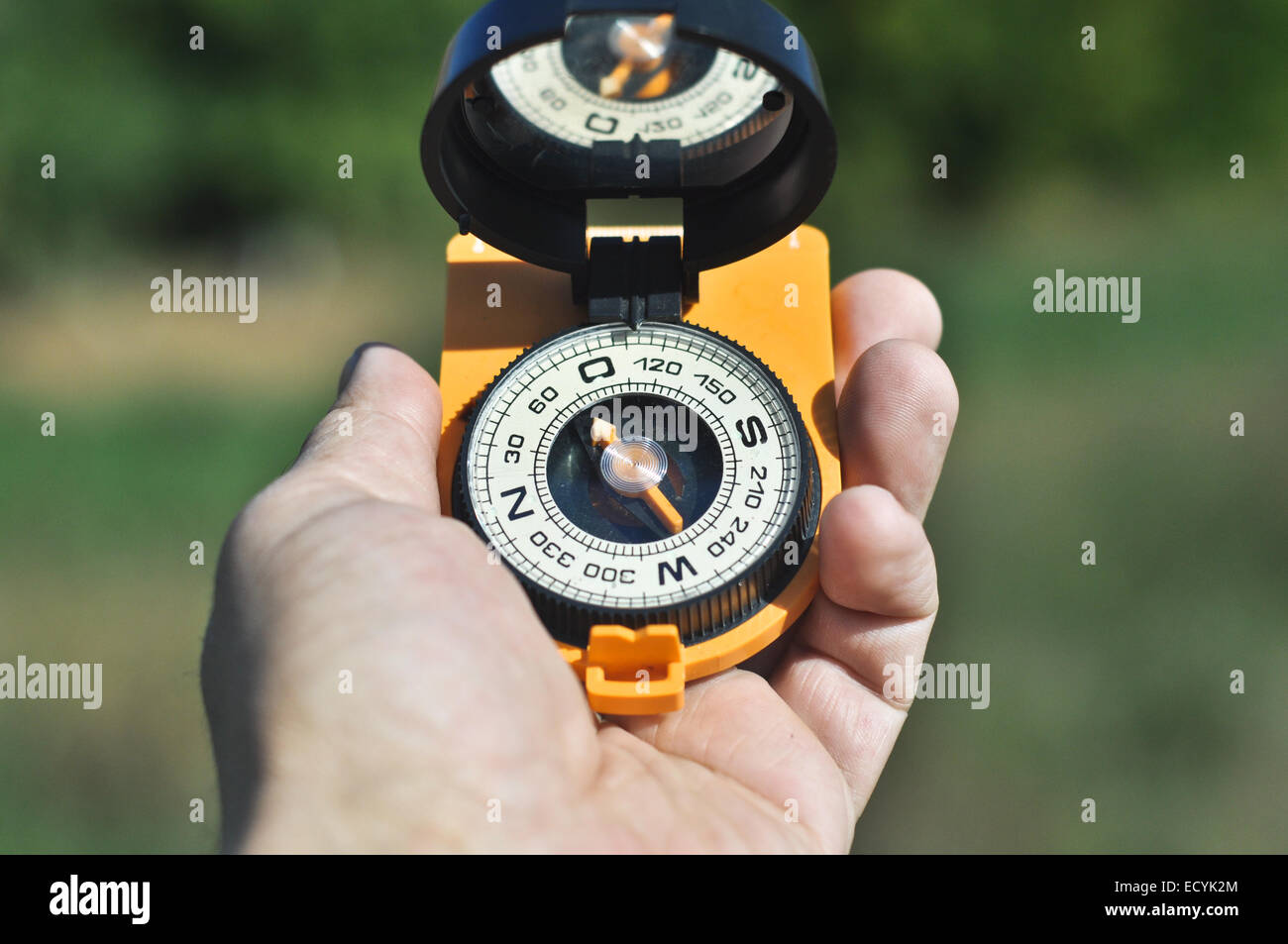 Compass in hand. The magnetic compass lies in a man's hand on a ...