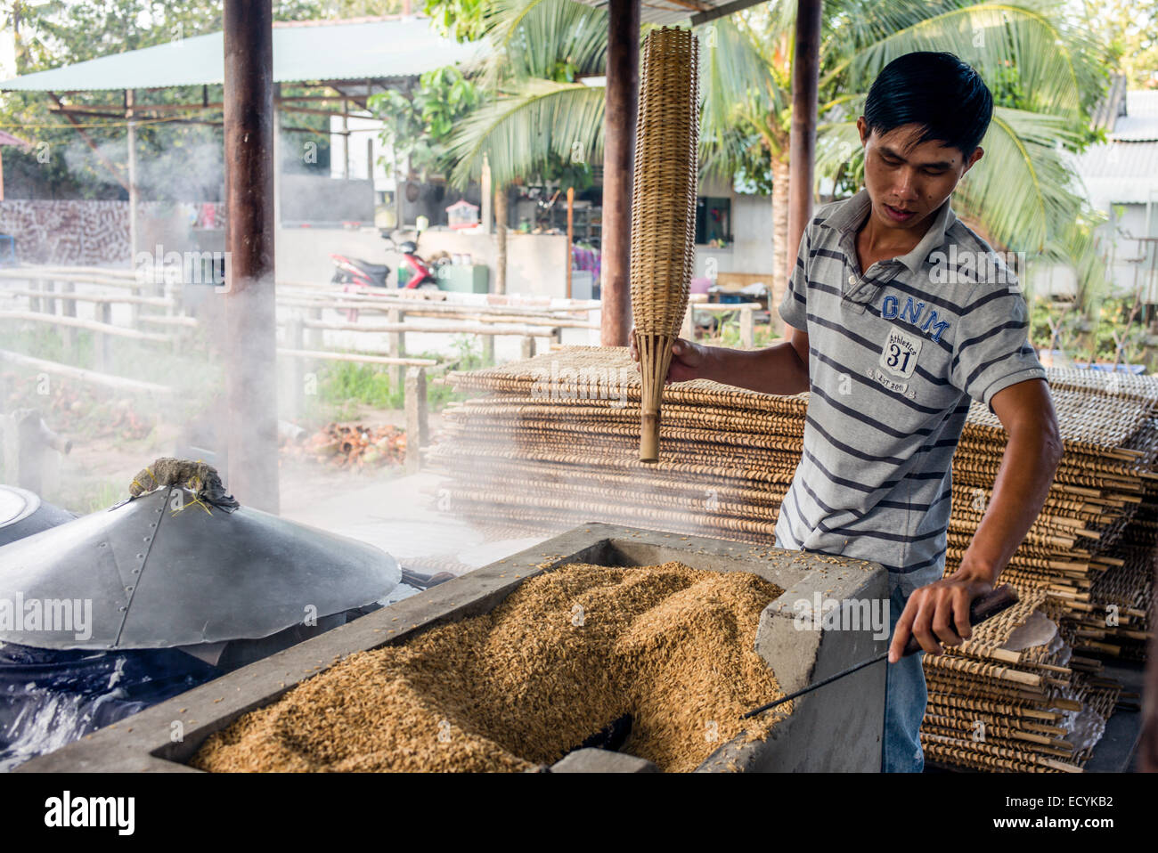 Vietnamese family working in their small home factory making rice paper ...