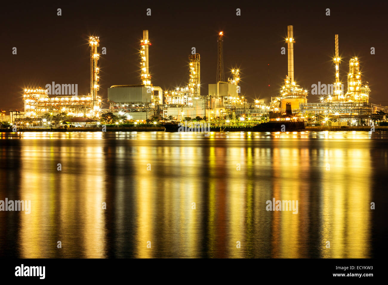 Oil Refinery Plant along river with tanker loading Stock Photo - Alamy
