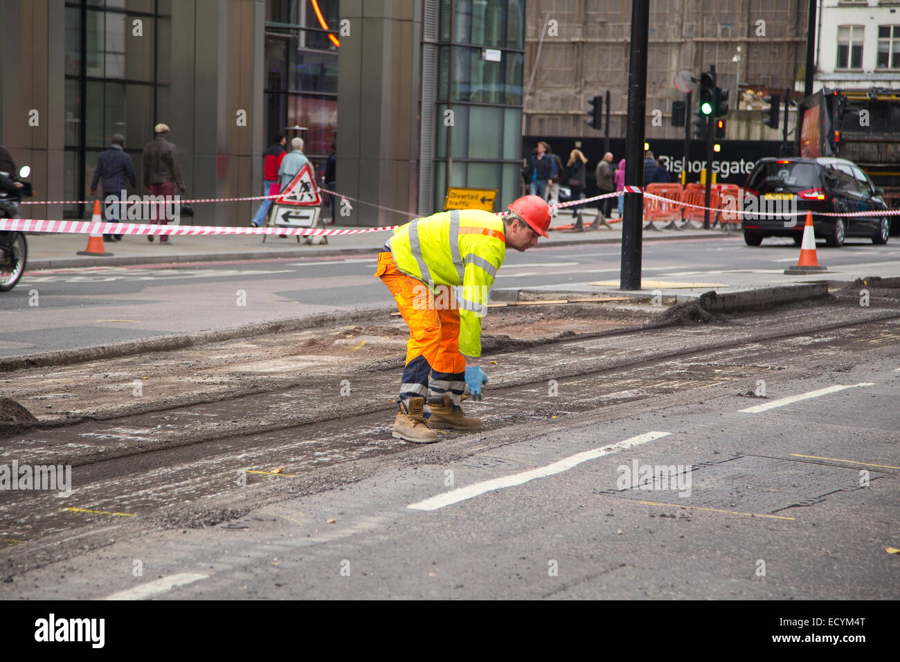 LONDON - OCTOBER 18TH: Unidentified workman resurfacing a road on ...