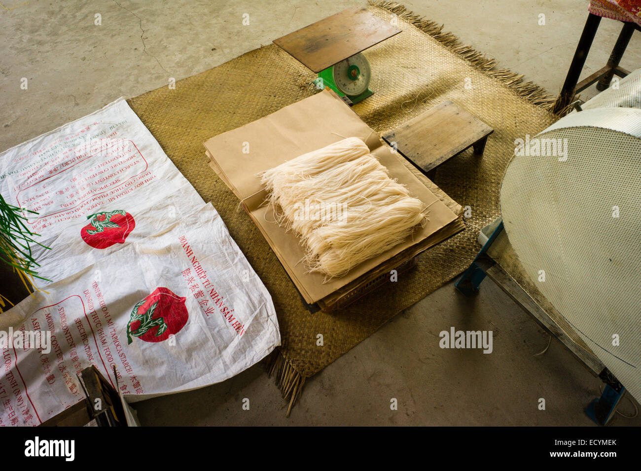 Vietnamese family working in their small home factory making rice paper ...