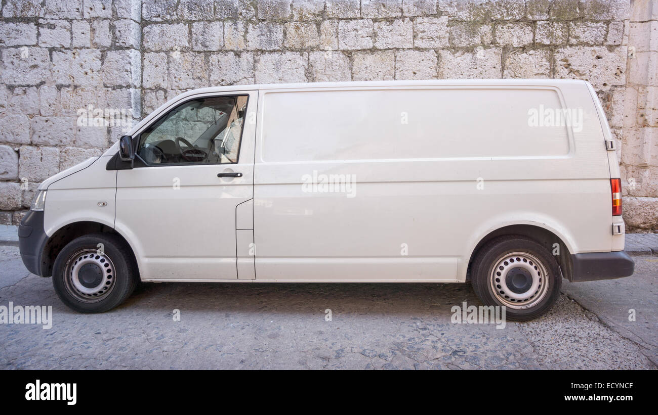 Van parked near old stone wall, side view Stock Photo - Alamy