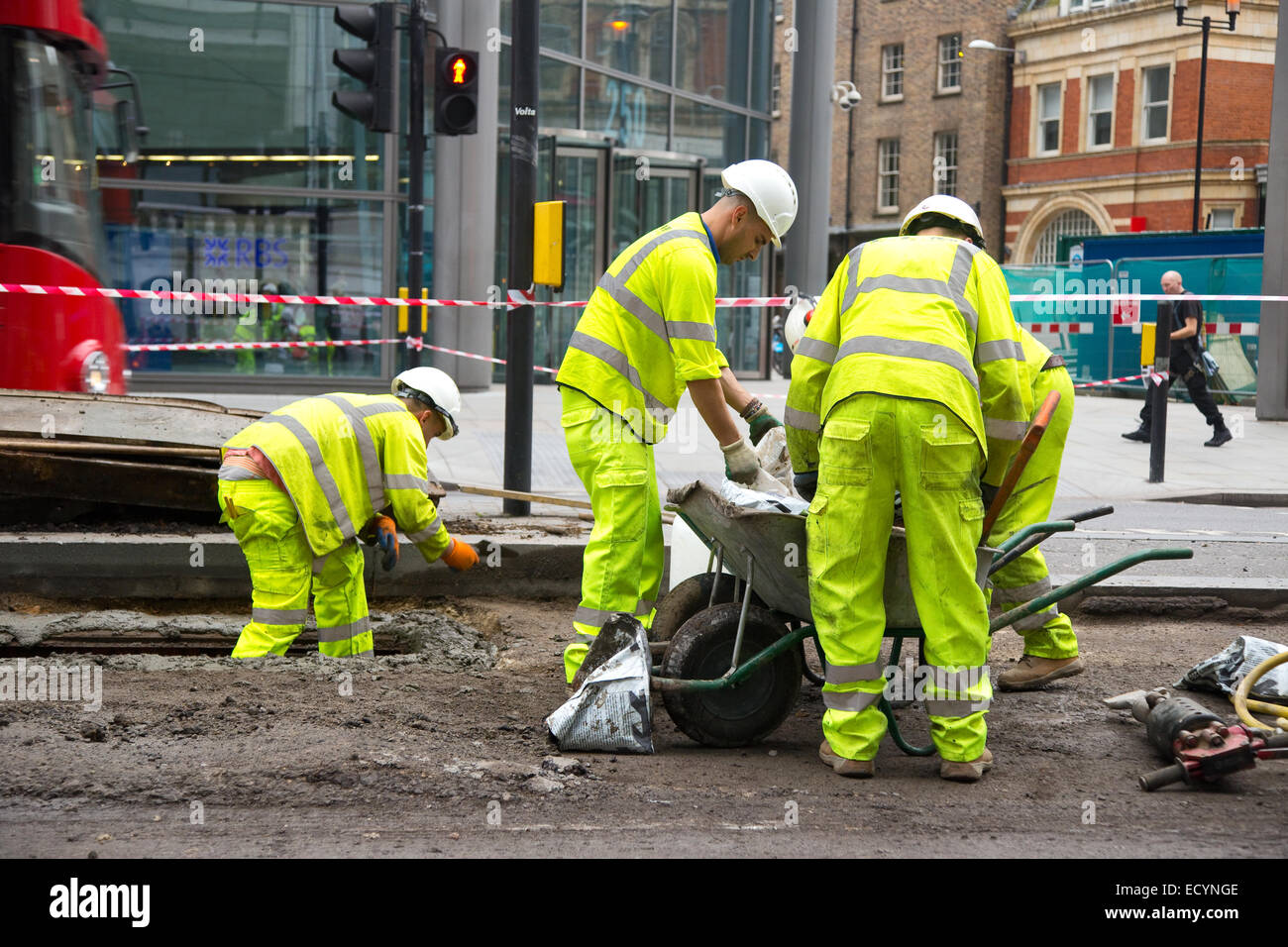 LONDON - OCTOBER 18TH: Unidentified workman preparing a mixture on ...