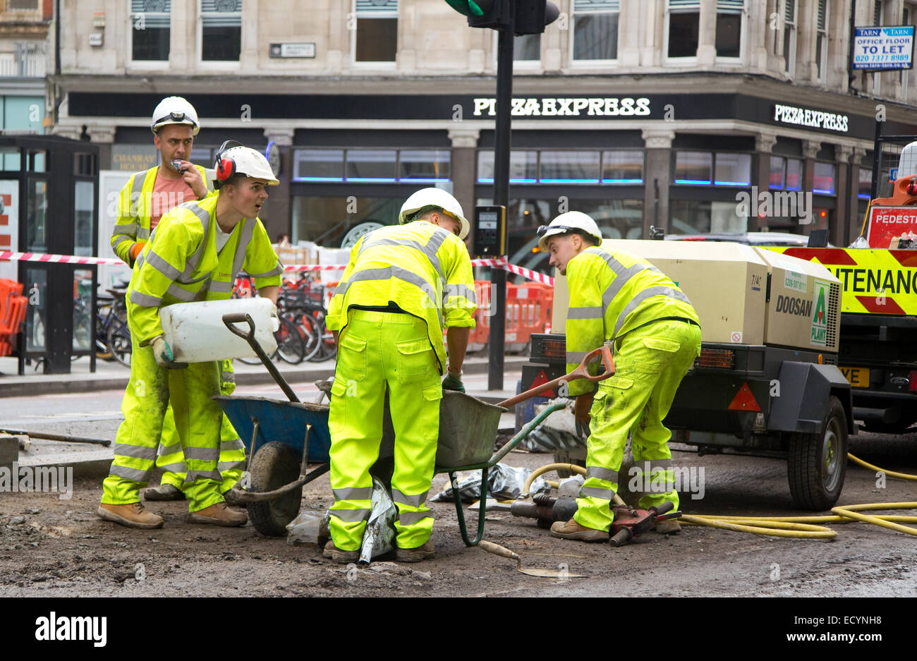 LONDON - OCTOBER 18TH: Unidentified workman preparing a mixture on ...