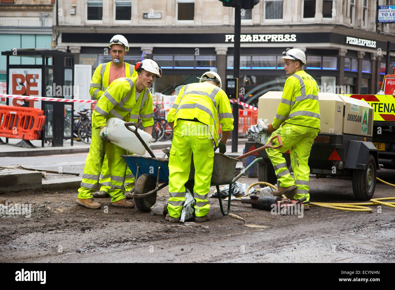 LONDON - OCTOBER 18TH: Unidentified workman preparing a mixture on ...