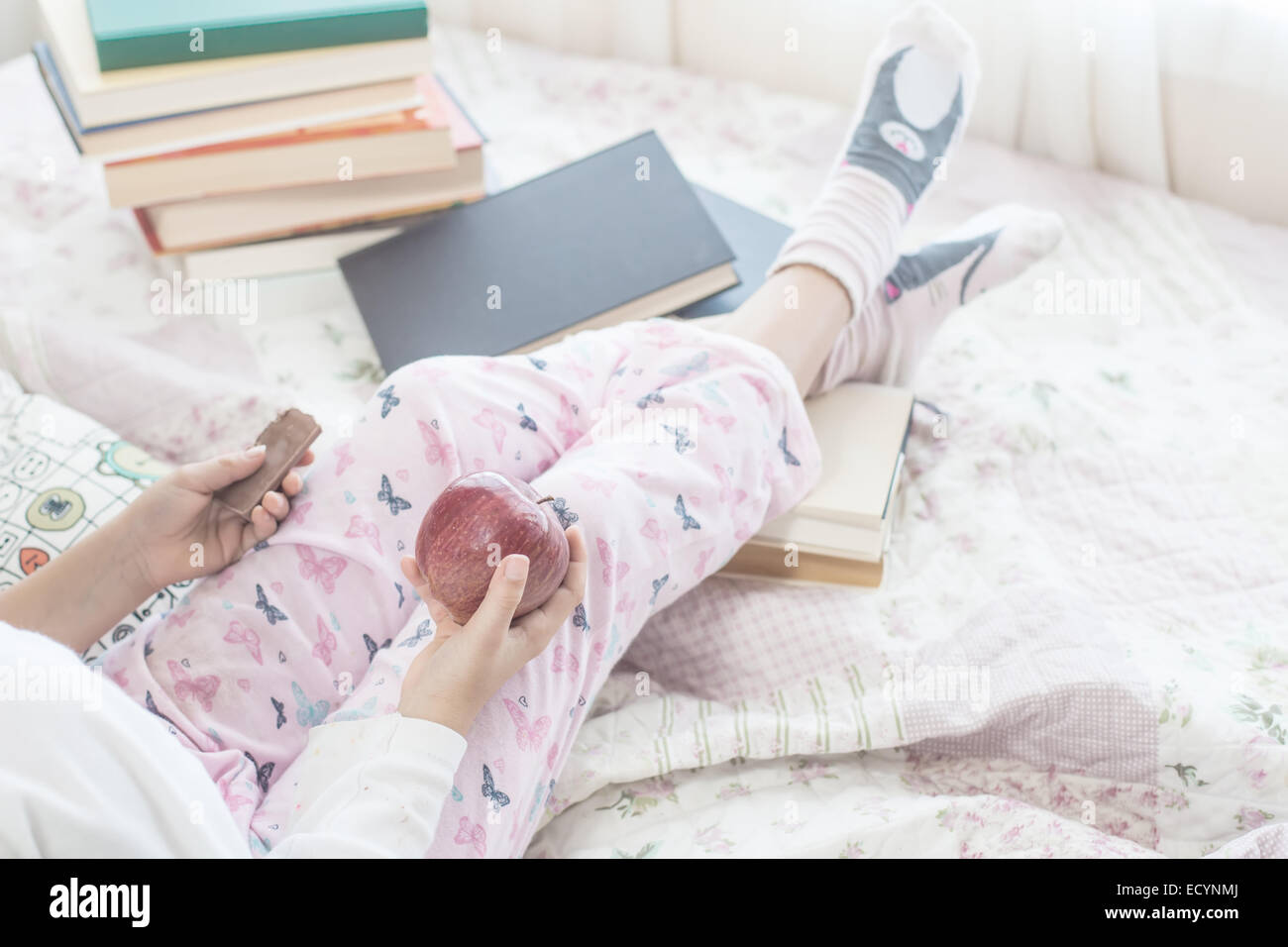 a girl reading a book while eat an apple. Vintage process Stock Photo ...