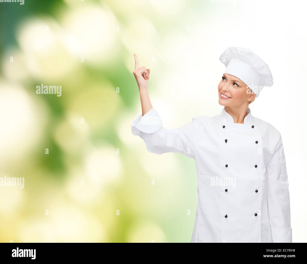 smiling female chef pointing finger to something Stock Photo - Alamy