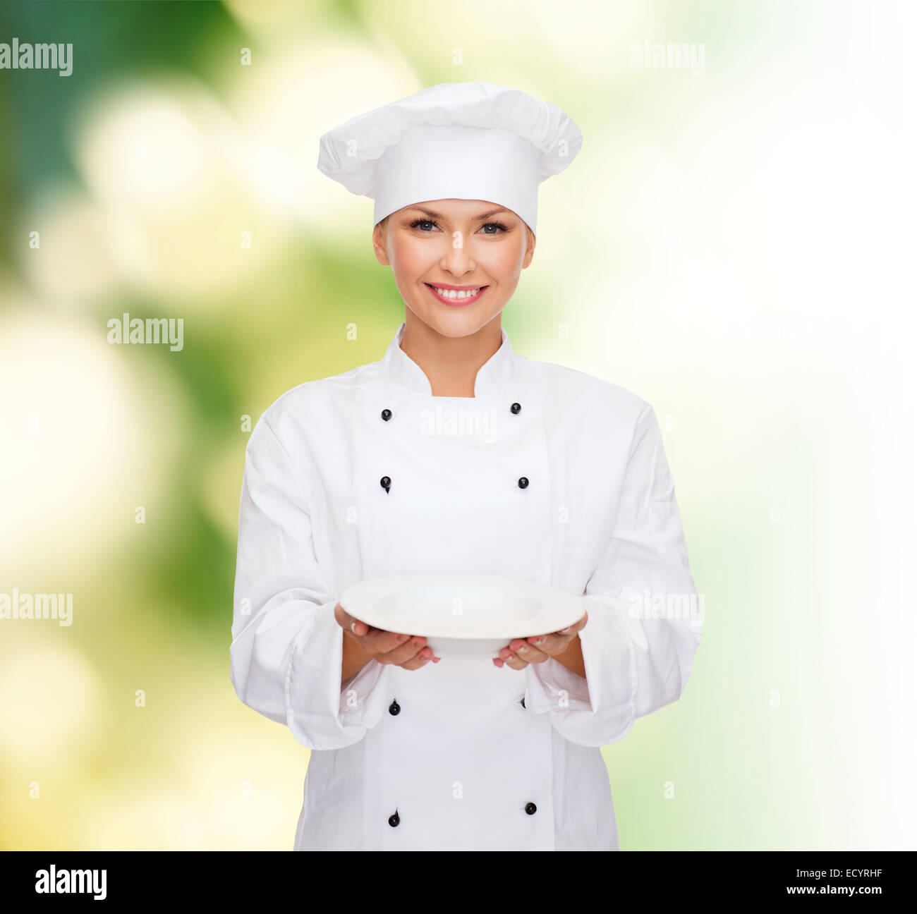 smiling female chef with empty plate Stock Photo - Alamy