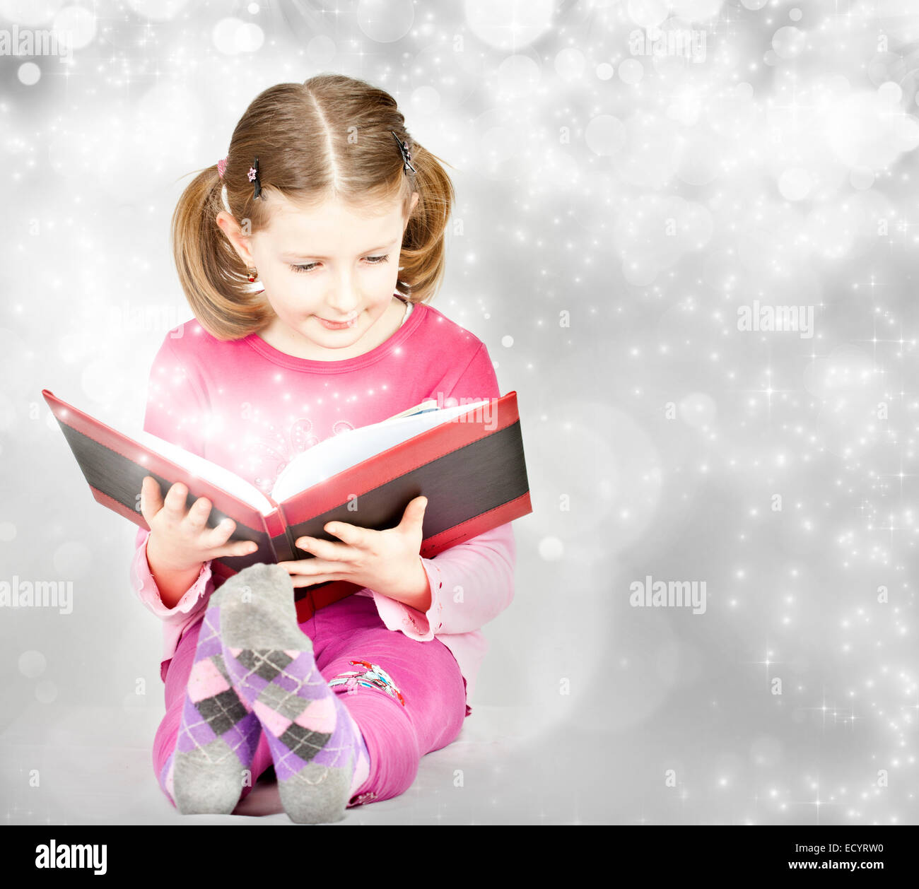Happy child reading magic book - Christmas concept Stock Photo - Alamy