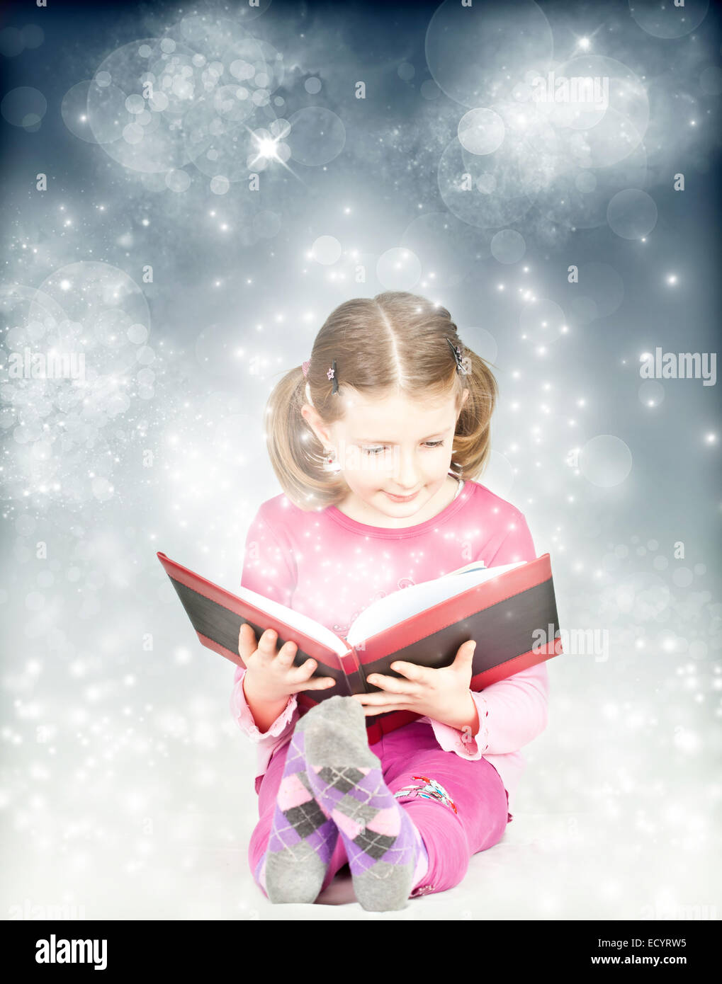 Happy child reading magic book - Christmas concept Stock Photo - Alamy