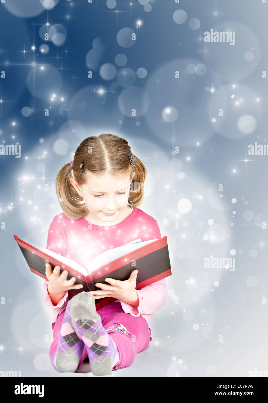 Happy child reading magic book - Christmas concept Stock Photo - Alamy
