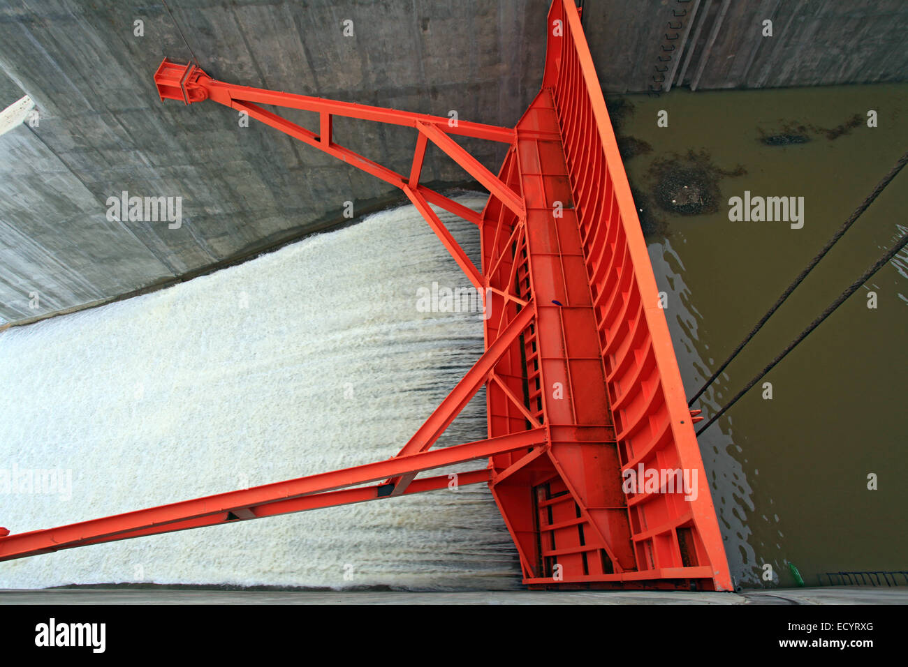 flowing water from red dam Stock Photo - Alamy