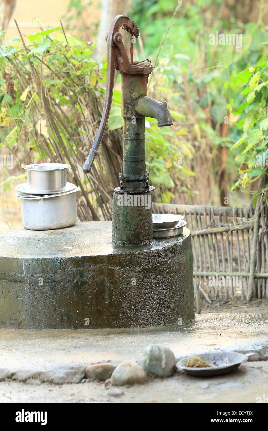 Old cast iron hand water pump along with some aluminum pans to wash ...