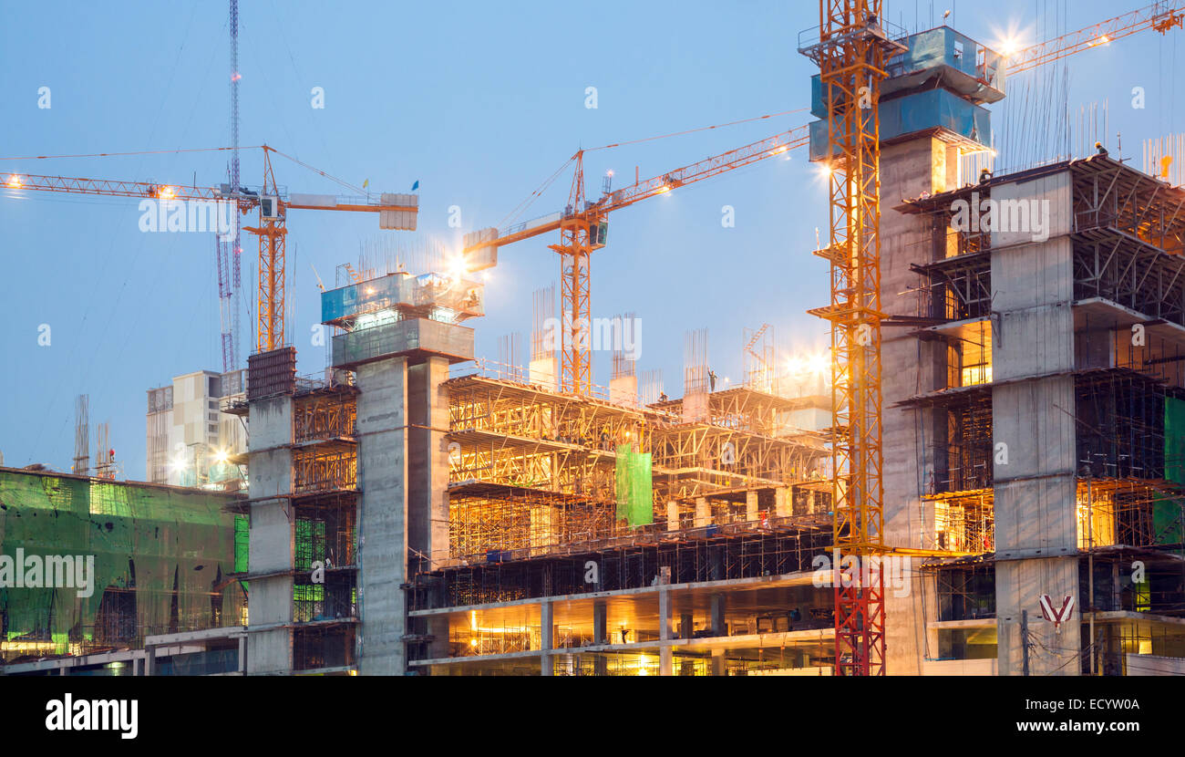 Big Construction Site Cranes at dusk Stock Photo - Alamy