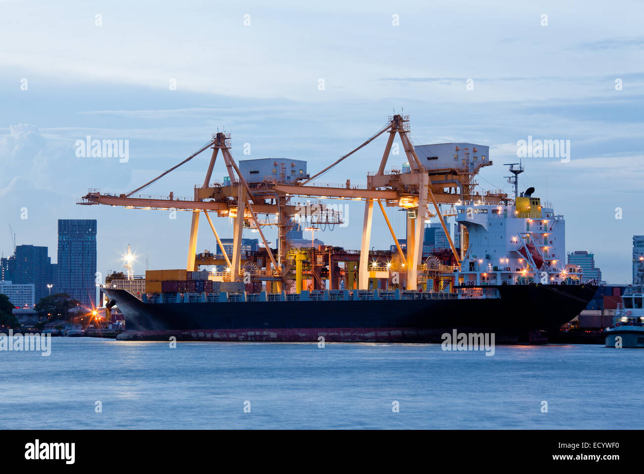 Container Cargo freight ship with working crane bridge in shipyard at ...