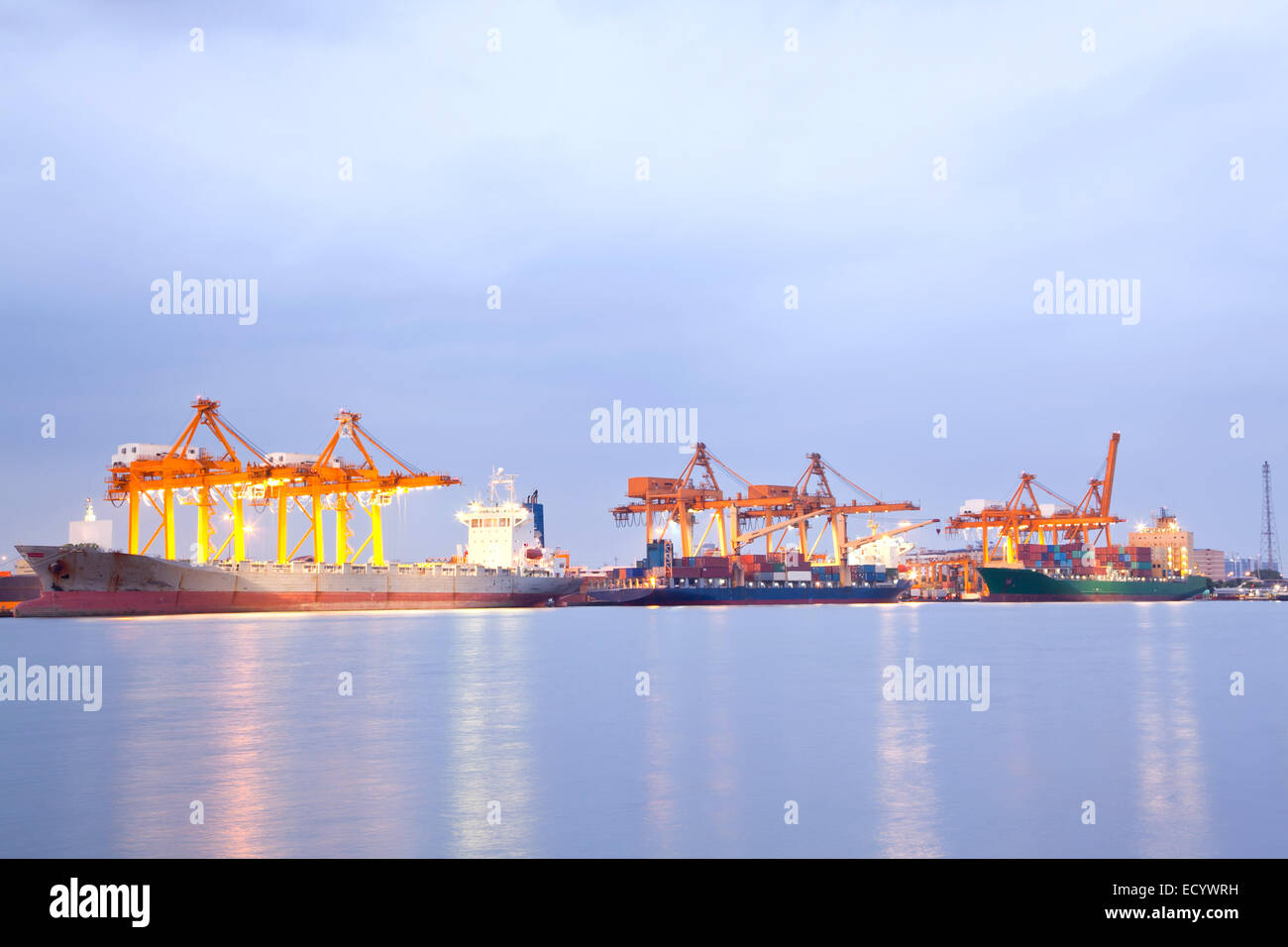 Big Container Cargo freight ship with working crane in shipyard at ...
