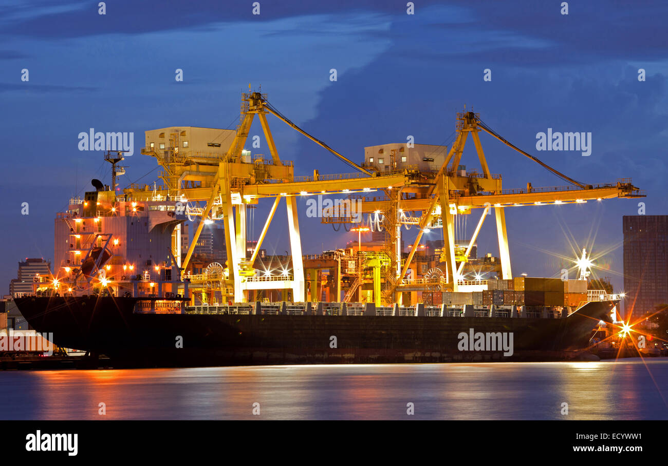Container Cargo freight ship with working crane bridge in shipyard at ...