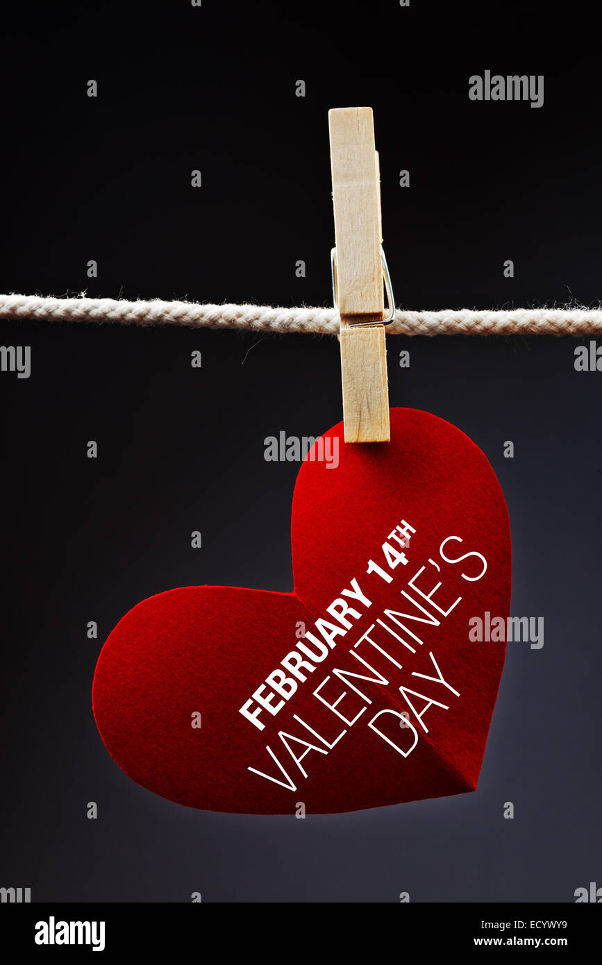 Heart shaped Valentine's Day card with message attached to a rope with ...
