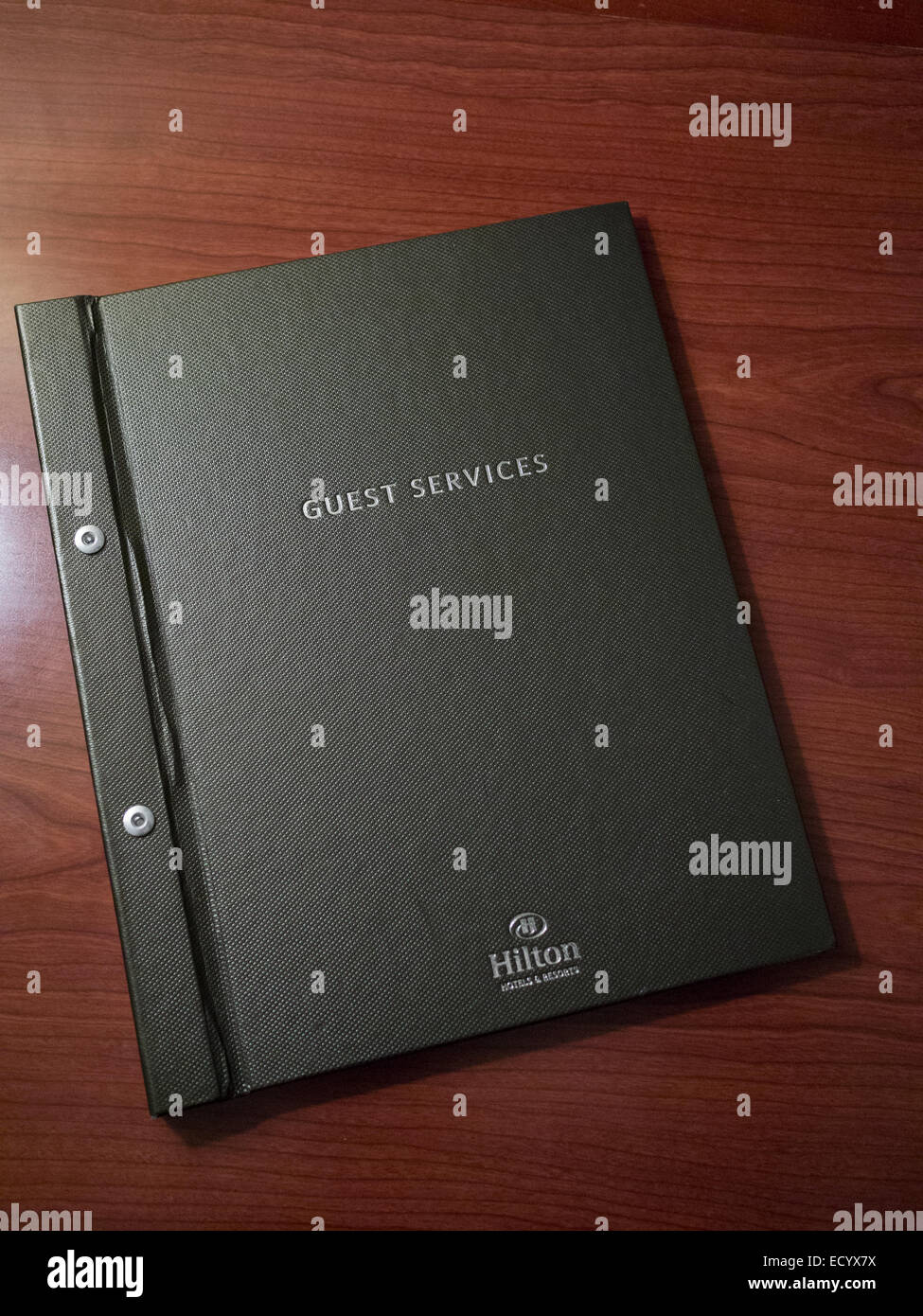 Hilton guest services binder wooden desk Stock Photo - Alamy