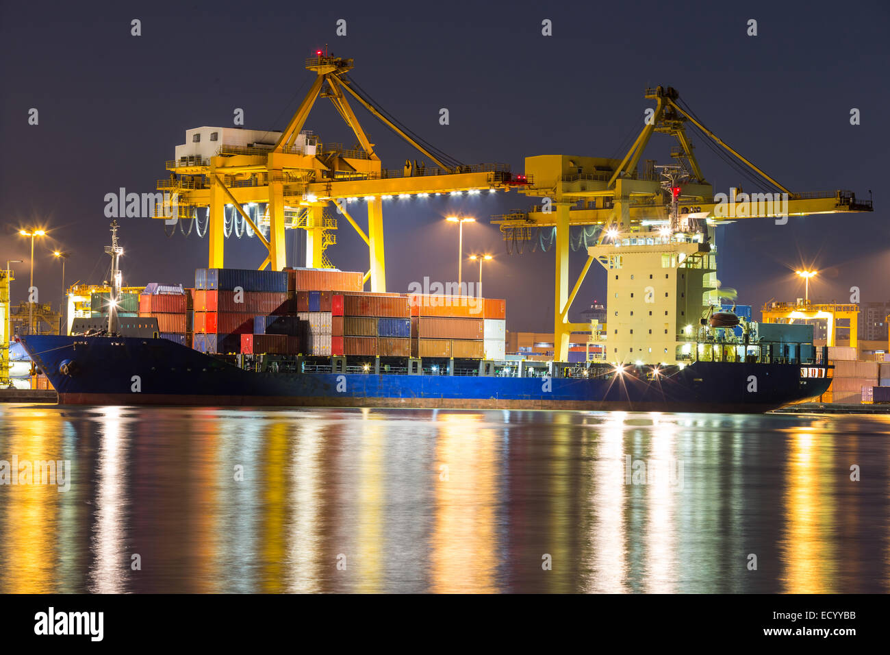 Container Cargo freight ship with working crane bridge in shipyard at ...