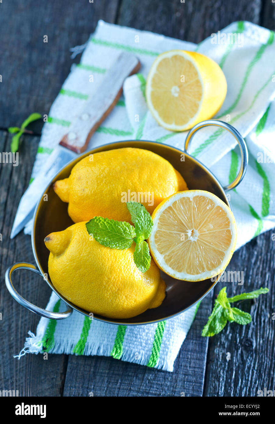 lemons in metal bowl and on a table Stock Photo - Alamy
