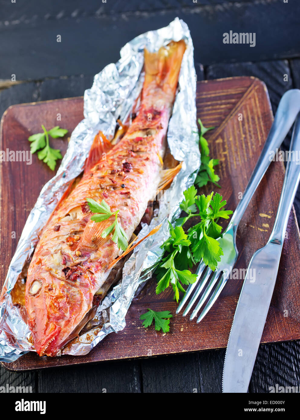 Fish in foil on barbecue hi-res stock photography and images - Alamy
