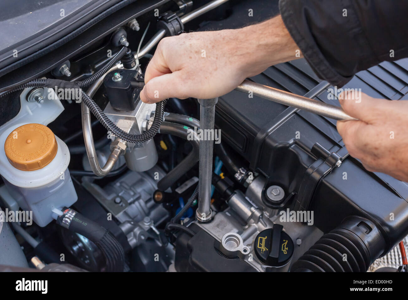 Hands repairing a car engine with a wrench Stock Photo - Alamy