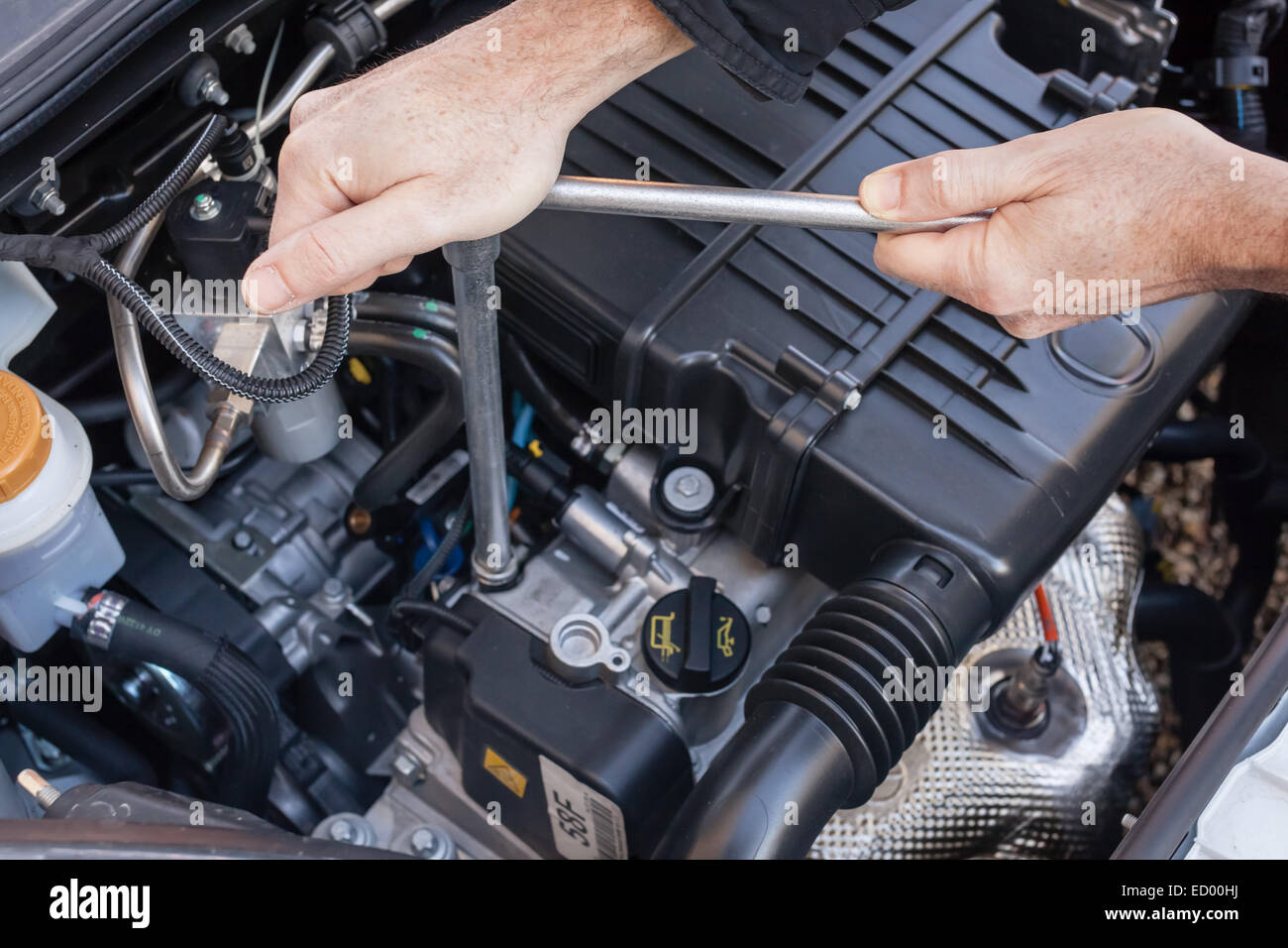Hands repairing a car engine with a wrench Stock Photo - Alamy