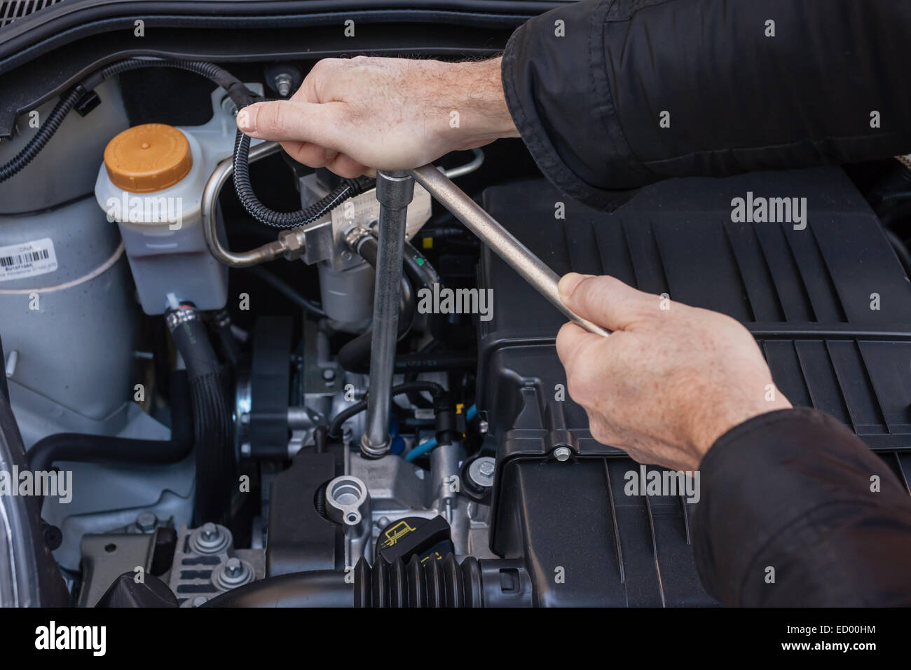 Hands repairing a car engine with a wrench Stock Photo - Alamy
