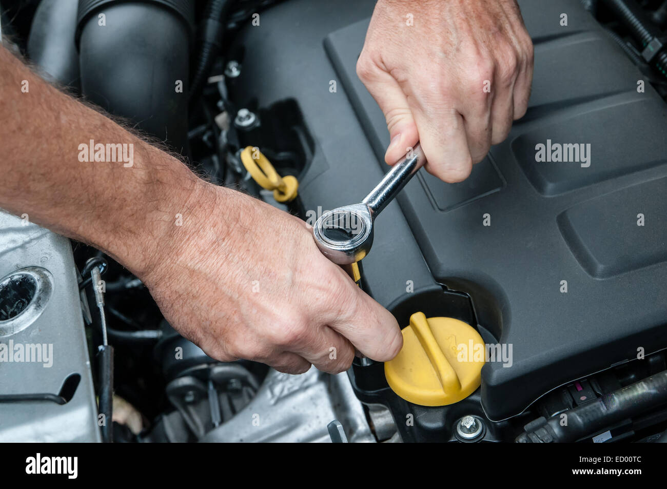 Hands repairing a car engine with a wrench Stock Photo - Alamy