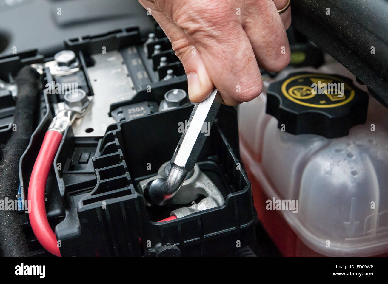 Hand repairing a car engine with a wrench Stock Photo - Alamy