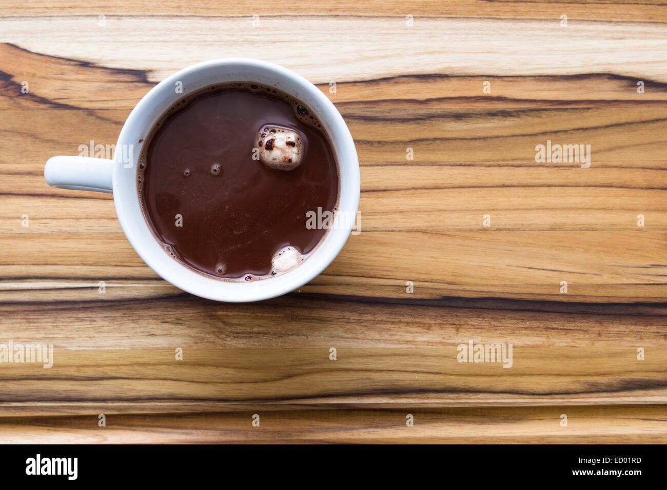 steaming cup of hot cocoa over a tropical teak wood background Stock ...
