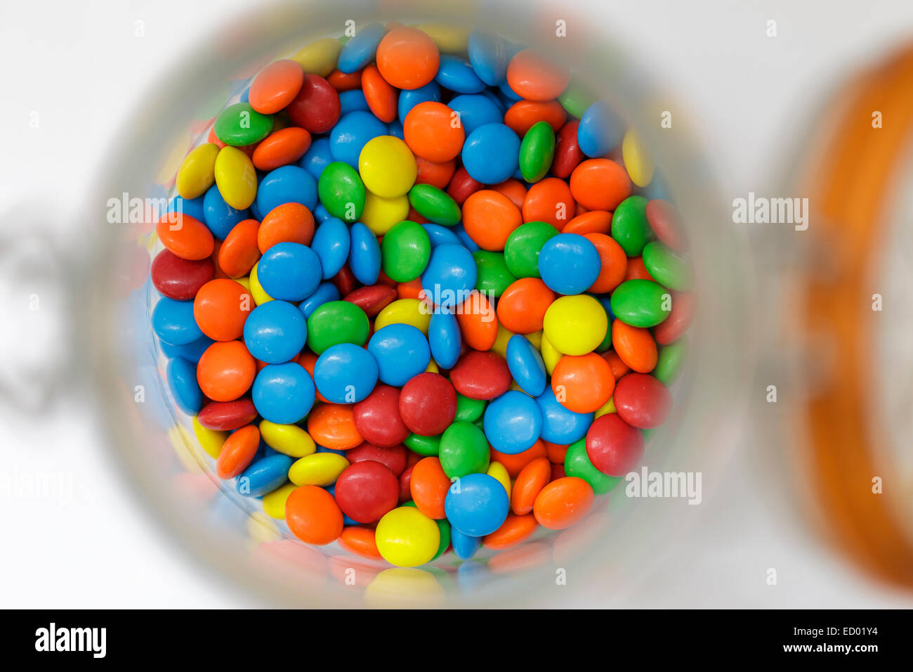 A lot of smarties in a big pot, white background Stock Photo - Alamy