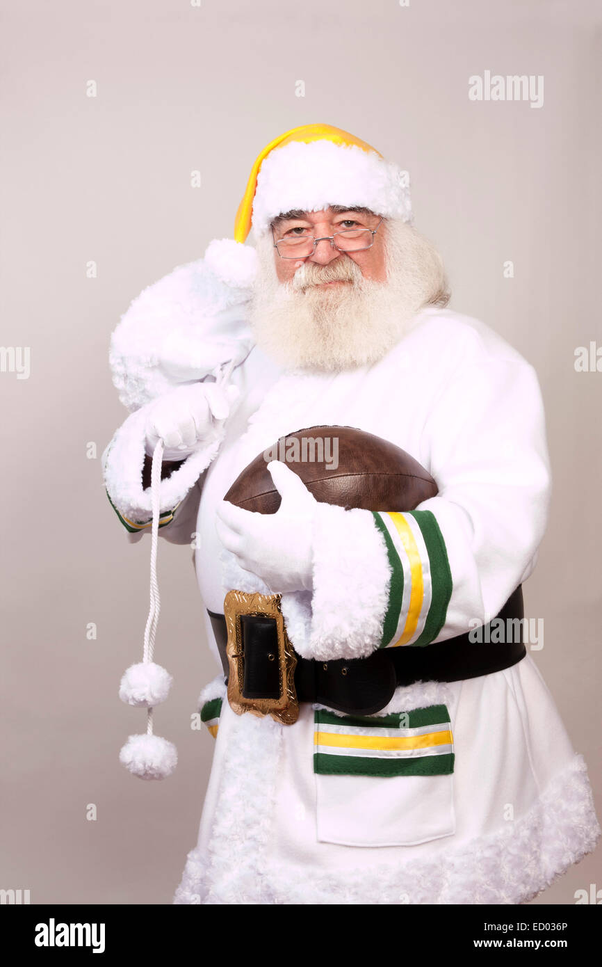 Green and Gold Packer Santa with a football Stock Photo - Alamy