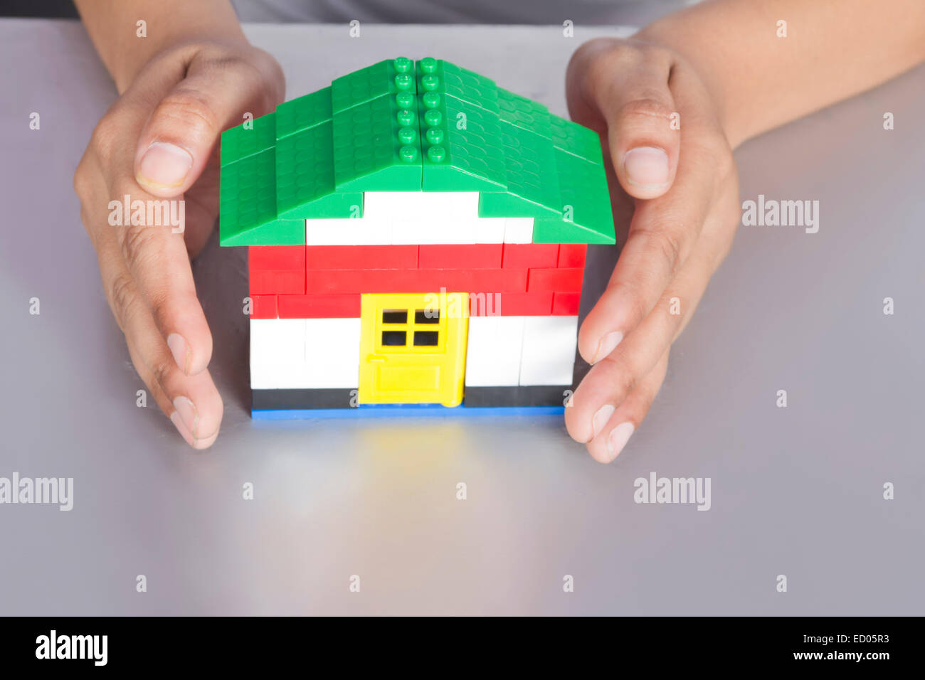 Female hand holding house model hi-res stock photography and images - Alamy