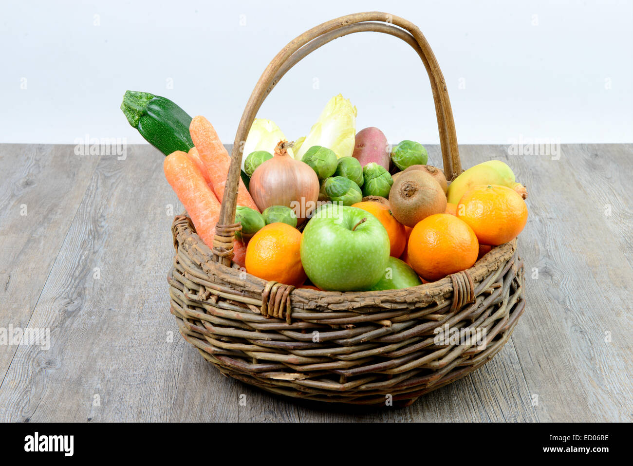 fruit and vegetable basket on the wooden table Stock Photo - Alamy
