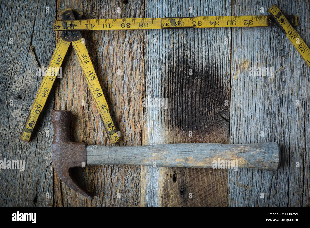 Old Tape Measure and Hammer for Construction on Rustic Wood Background ...