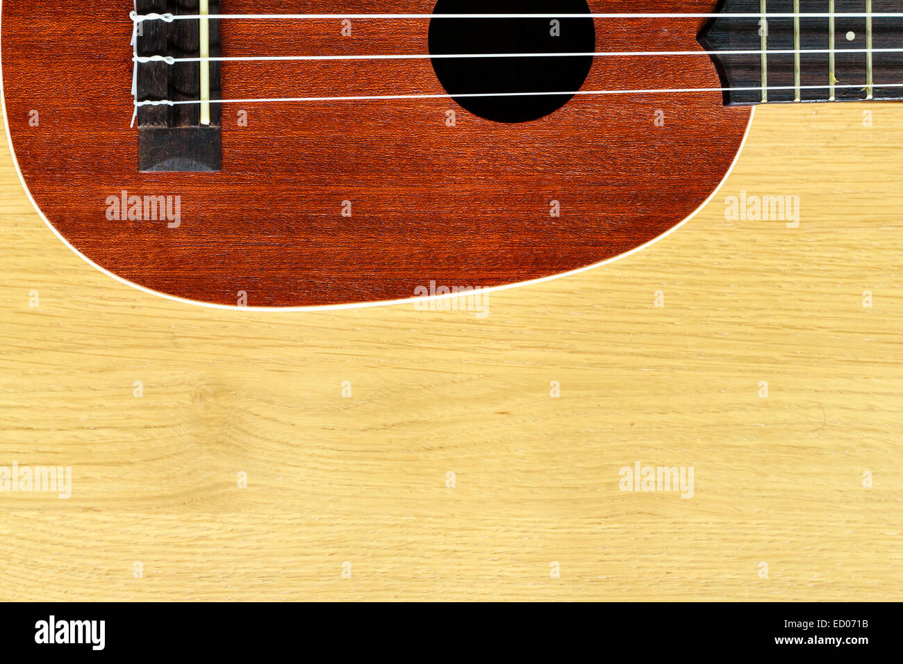 An ukulele on wood background , small guitar Stock Photo - Alamy