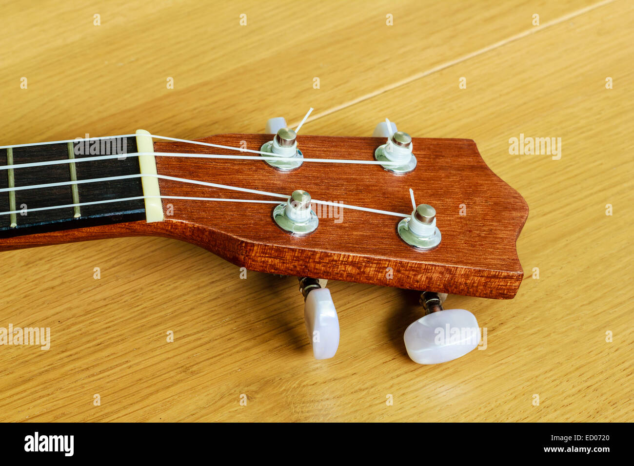 An ukulele on wood background , small guitar Stock Photo - Alamy