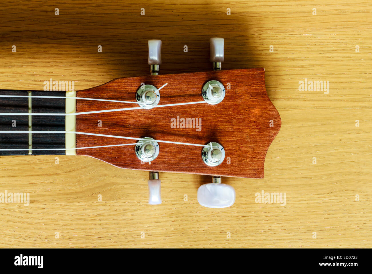 An ukulele on wood background , small guitar Stock Photo - Alamy