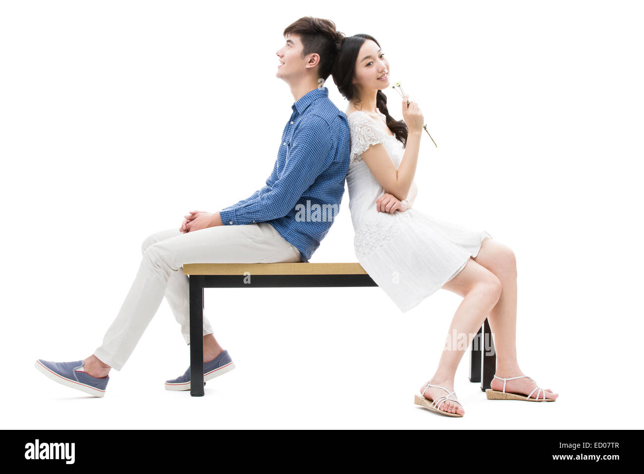 Happy young couple back to back Stock Photo - Alamy