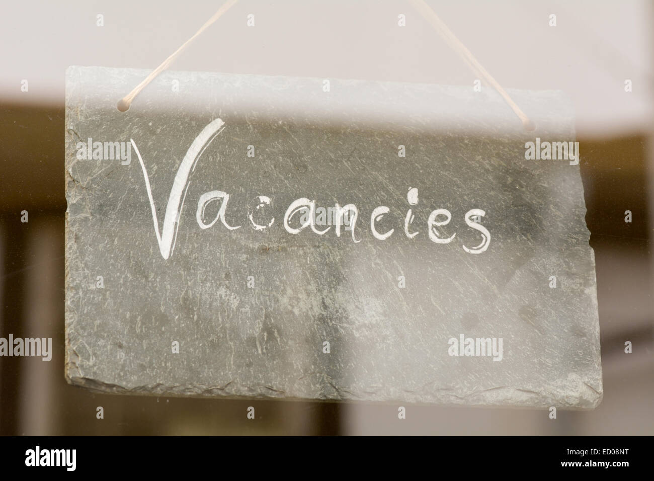 Vacancies sign in hotel window Stock Photo - Alamy