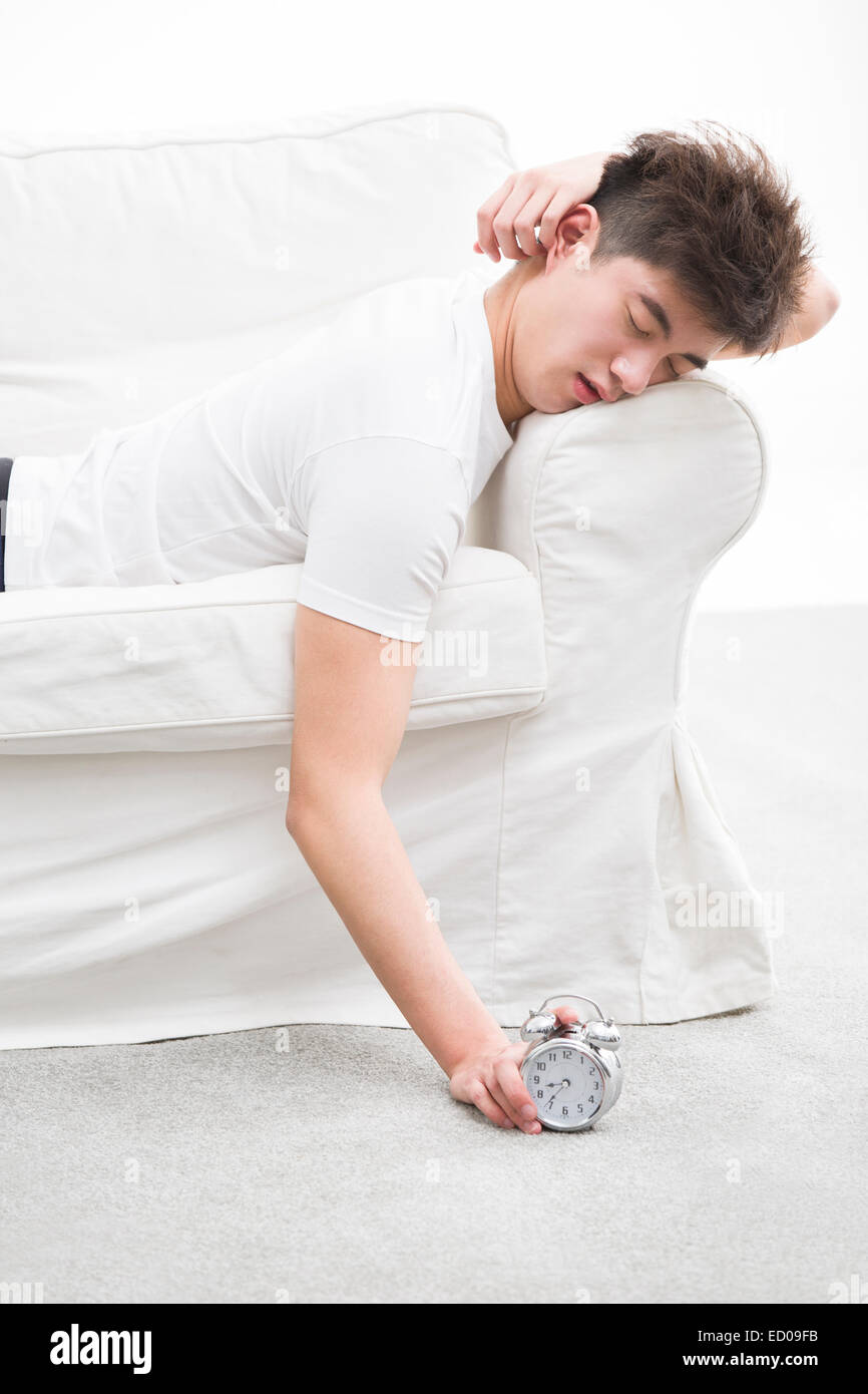 Young man sleeping on couch Stock Photo - Alamy